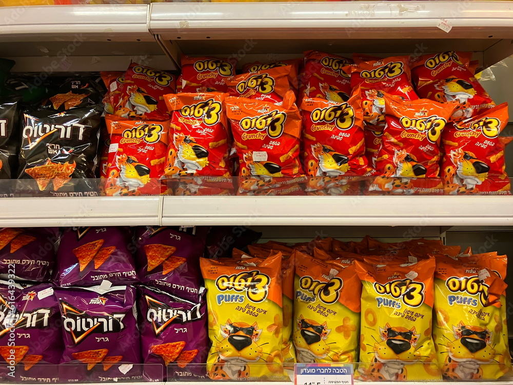 Display with snacks in a store. Translation: Bissli, chips, bamba ...