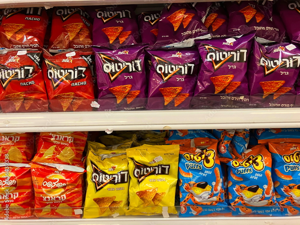 Display with snacks in a store. Translation: Bissli, chips, bamba ...