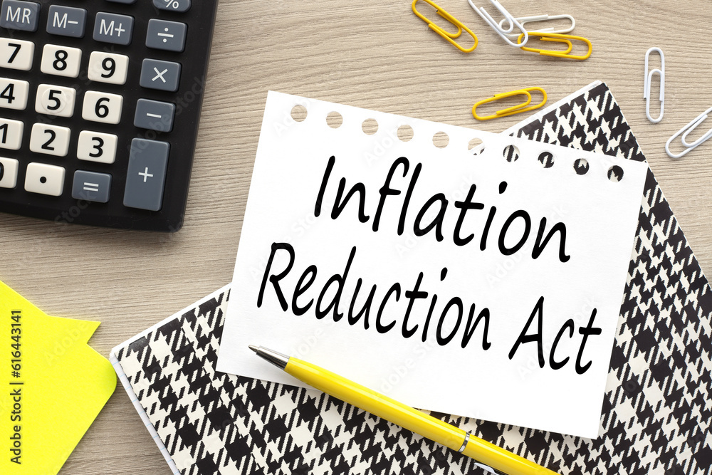 Inflation Reduction Act open notepad near stickers. yellow pen. text on ...