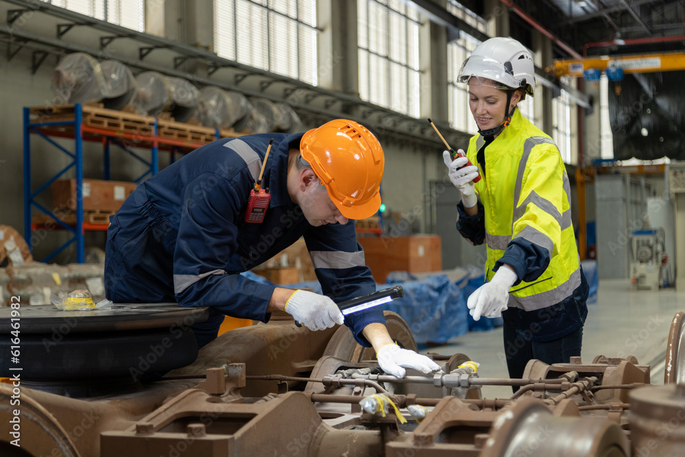 Two professional engineers check mechanical check undercarriage of ...