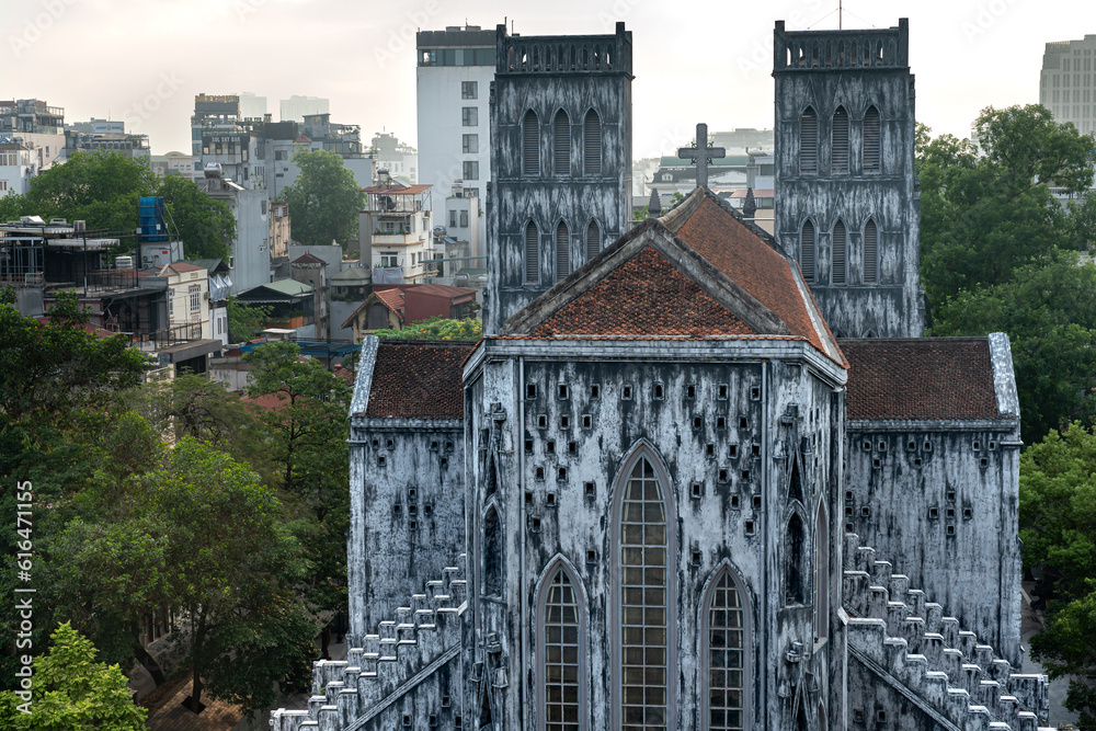 Behind the cathedral in Hanoi, Vietnam. The church is designed in the ...