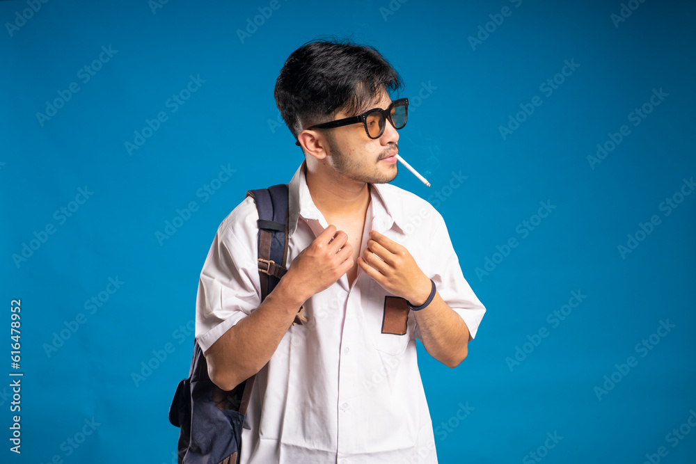 Foto de Hooligan high school student smoking cigarette while looking ...