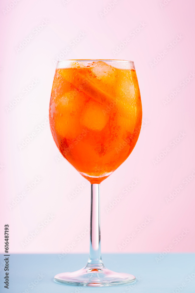 Aperol Spritz cocktail in glass on a pink blue background. Cocktail ...