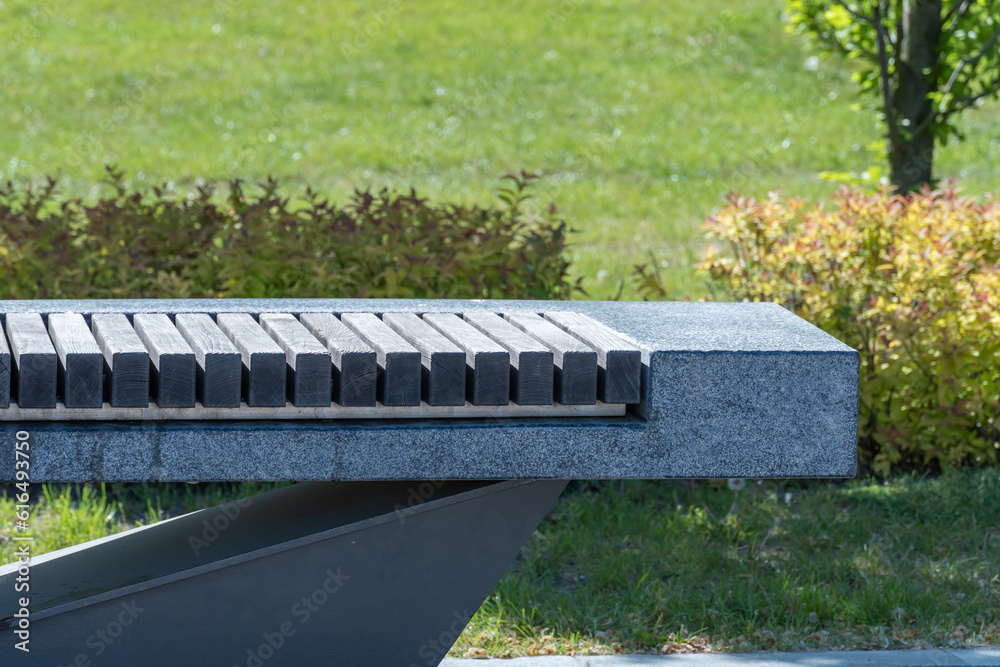 Comfortable in stone and wooden material bench in city park. Design of ...