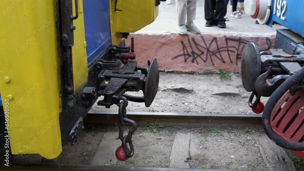 Close-up detail of iron connection of two train wagons before docking ...