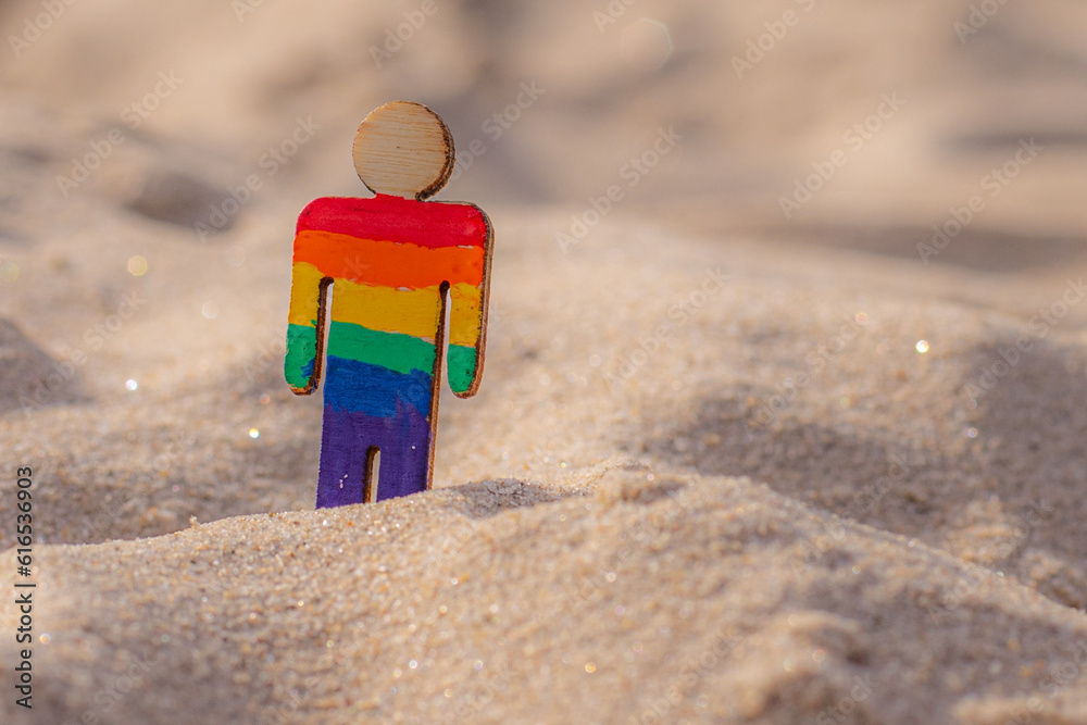 LGBT wooden people on the beach on the sand. Couple standing on beach ...