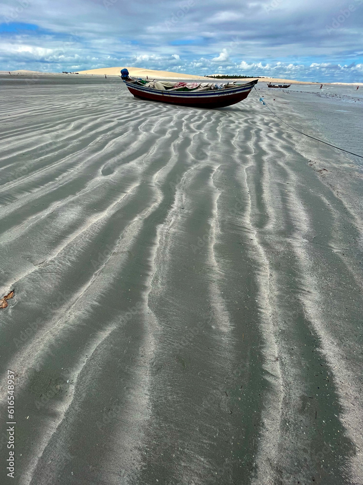 Brazil: fishing boat and low tide on Praia Principal de Jeri, the main ...