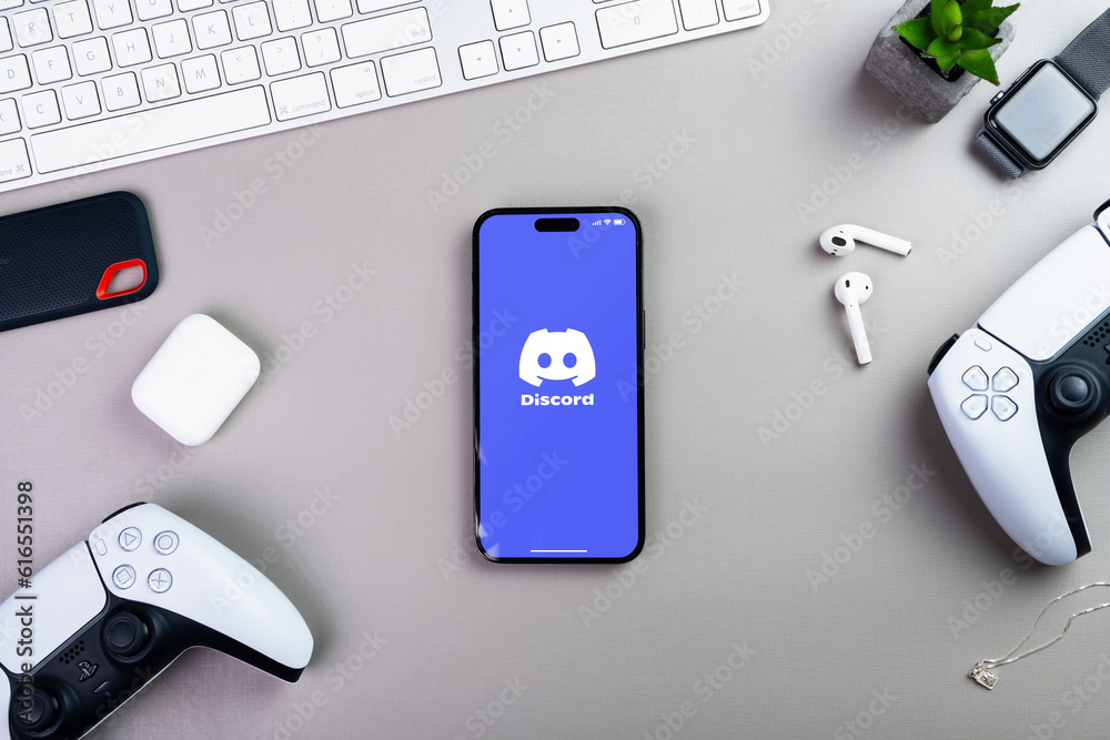 Discord app on the smartphone iPhone 14 Pro screen on gray table with ...