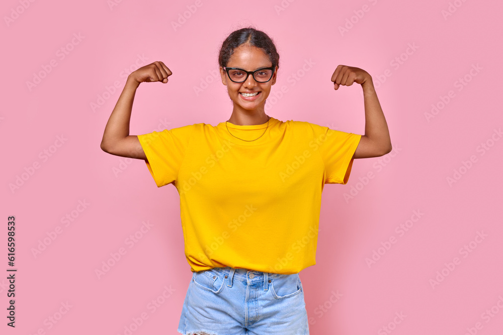 Young strong happy Indian woman with smile assumes pose of strongman ...