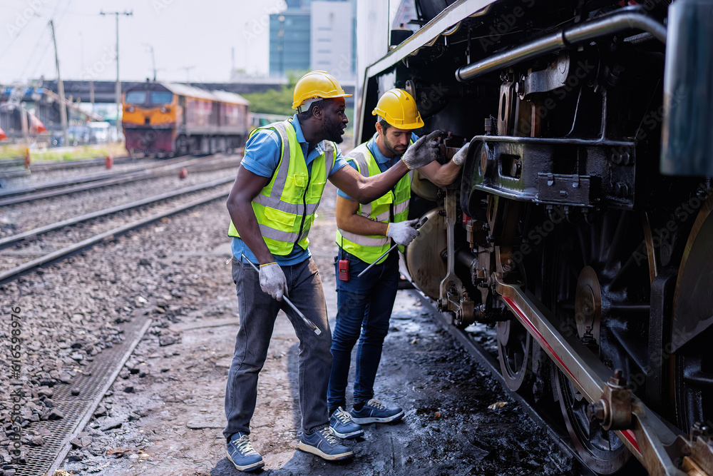 Engineer railway wearing safety gear checking train transmittal system ...