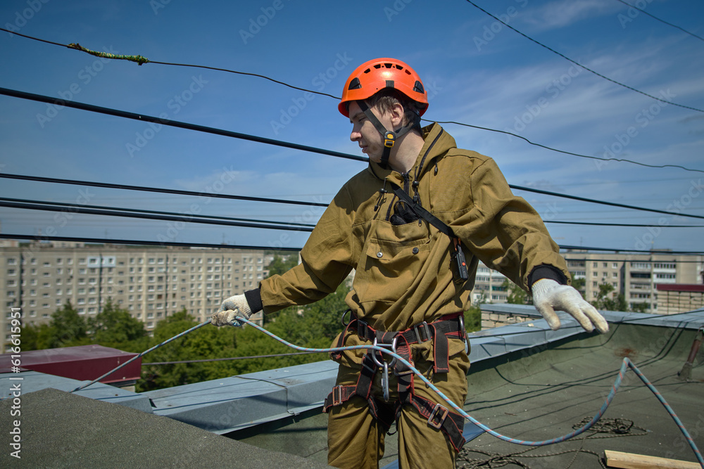 Foto de Rope access. A climber works on the roof of a house in the city ...