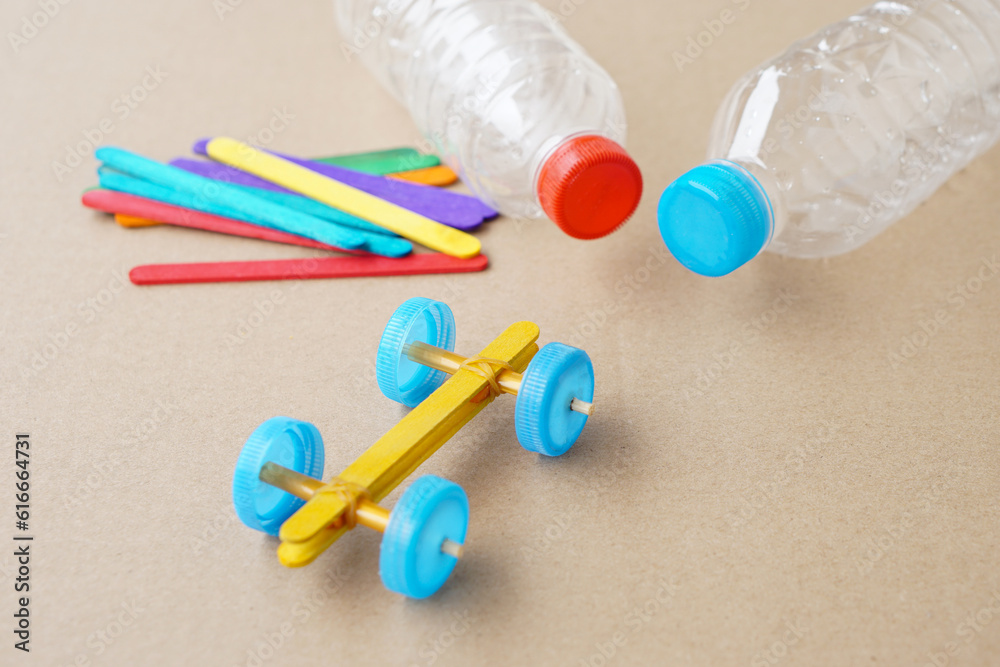 Handmade toy racing car made from ice cream sticks and bottle caps ...