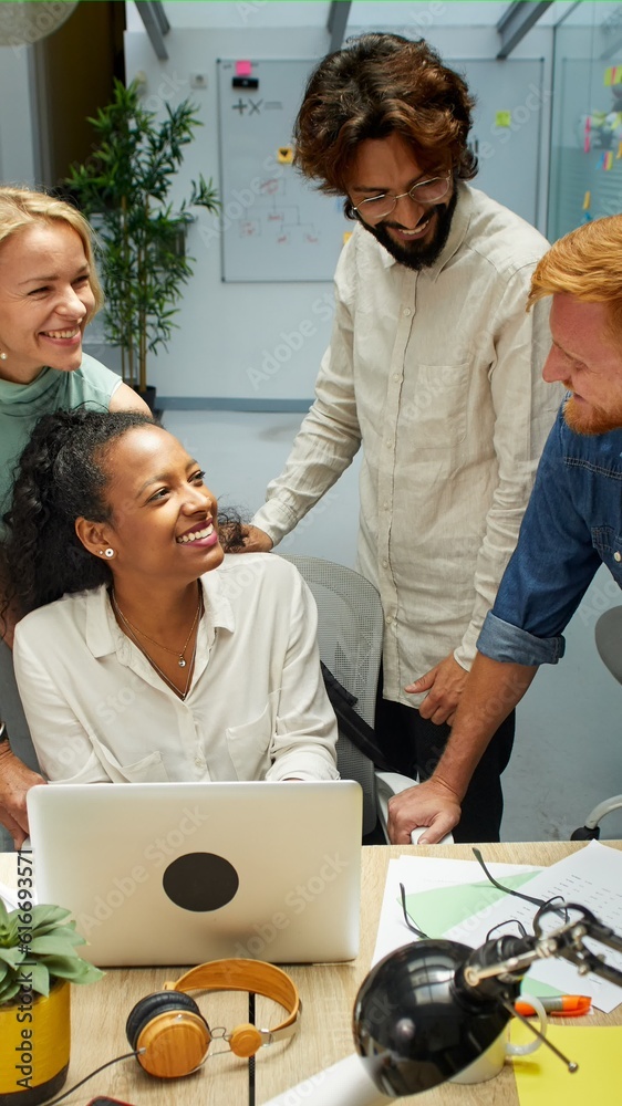 Vertical. Group of professional multirracial men and women working at ...