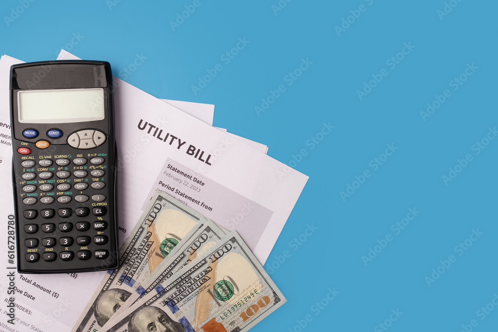 Calculator and utility bill, Energy bill showing electricity and gas ...