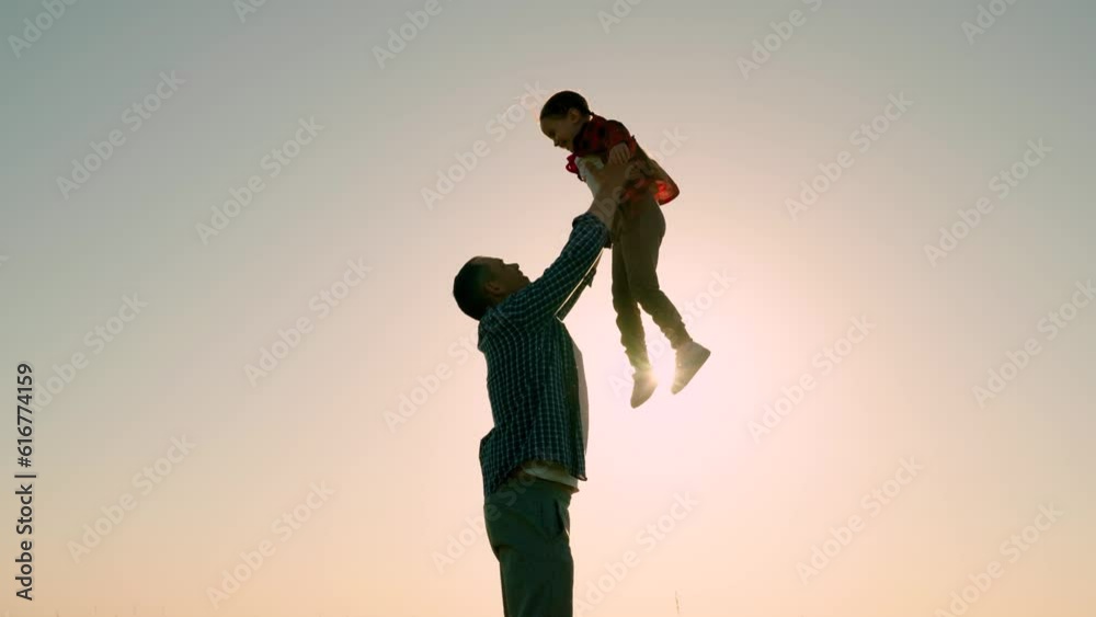 Dad is playing with child in park, girl dreams of flying and being ...