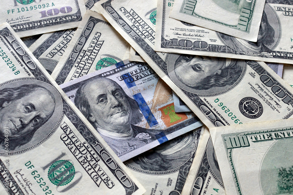 A pile of one hundred US dollars - Banknotes. Cash of hundred dollar ...