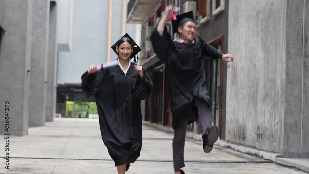 happy graduate teen people jumping with the graduation gowns in the ...
