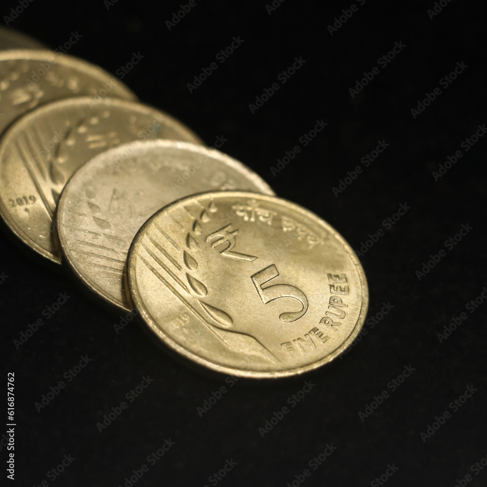 closeup of vintage 5 or five rupee gold coins of india arranged in a ...