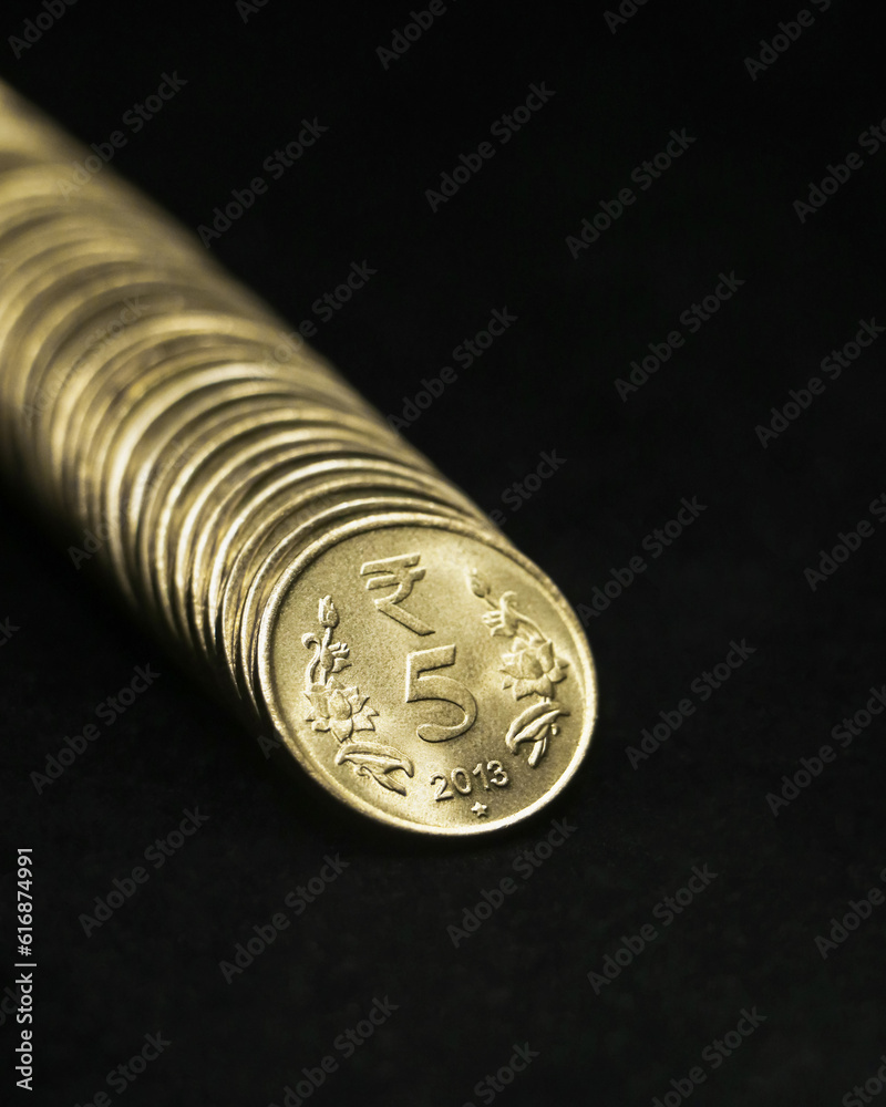closeup of vintage 5 or five rupee gold coins of india arranged in a ...