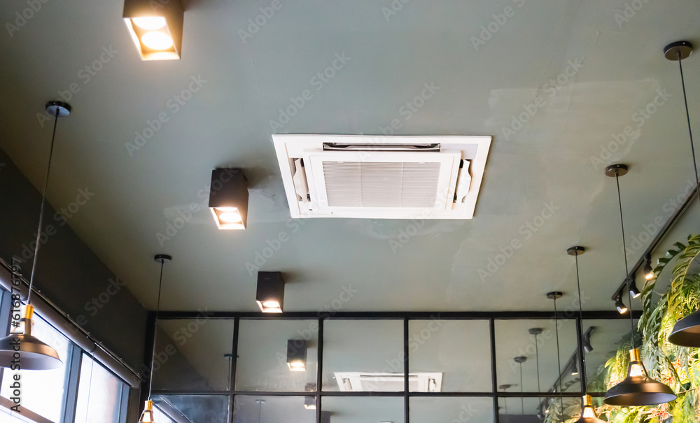 Modern ceiling mounted cassette type air conditioning system in coffee ...