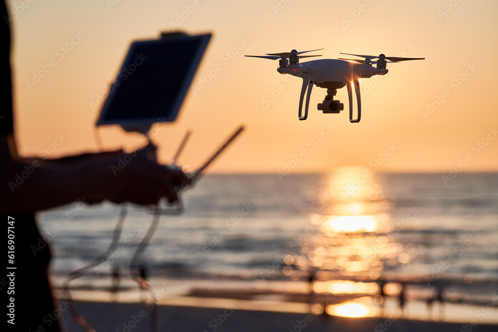 Drone operated by young man flying over an sea Stock Photo | Adobe Stock