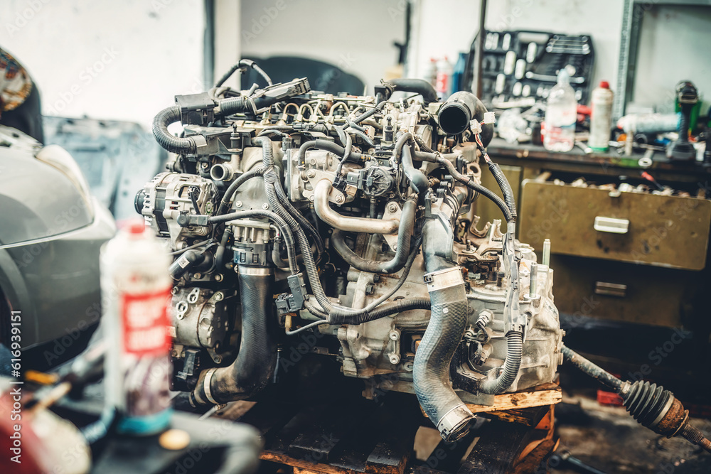 disassemble the engine from the car in the car workshop. Stock Photo ...