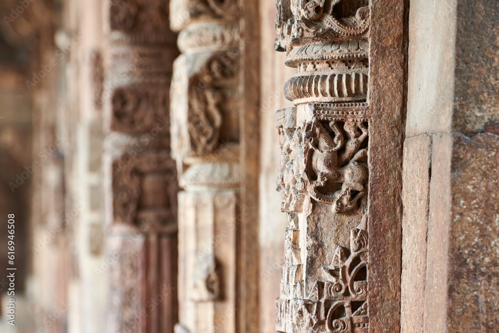 Stone columns with decorative bas relief of Qutb complex in South Delhi ...