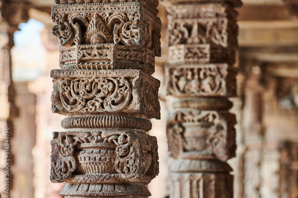 Stone columns with decorative bas relief of Qutb complex in South Delhi ...