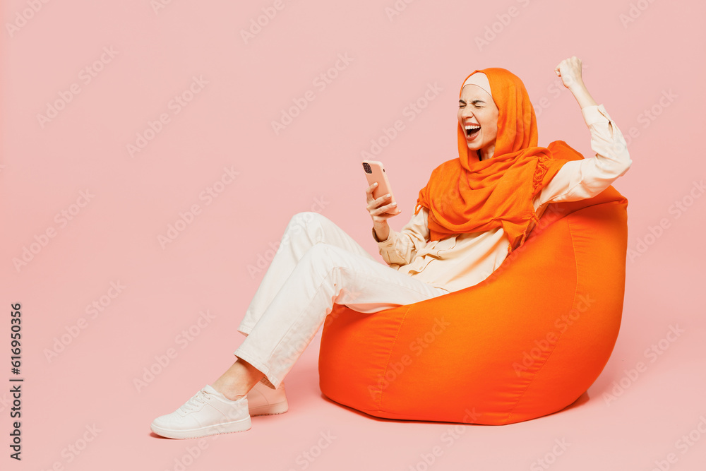 Full body young arabian asian muslim woman wears abaya hijab sit in bag ...