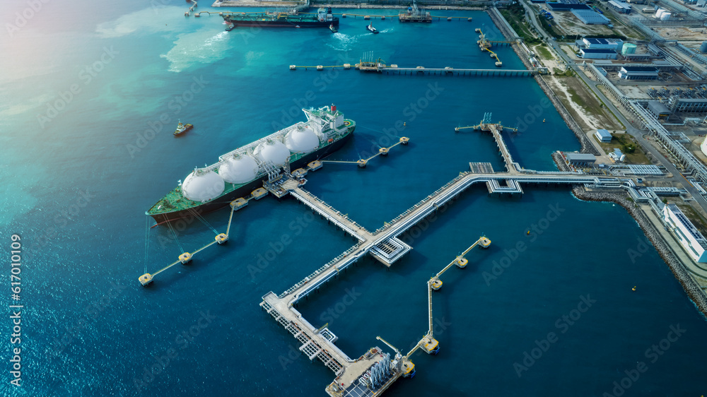 LNG (Liquified Natural Gas) tanker anchored in Gas terminal gas tanks ...