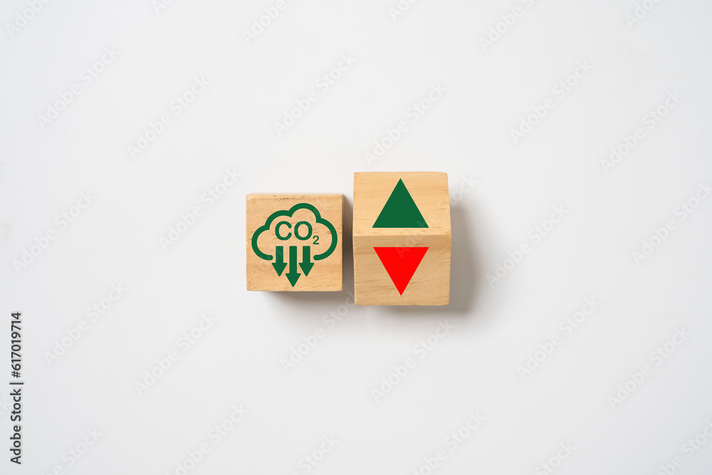 CO2 reducing icon print screen on wooden cube and up down arrow for decrease CO2 , carbon ...