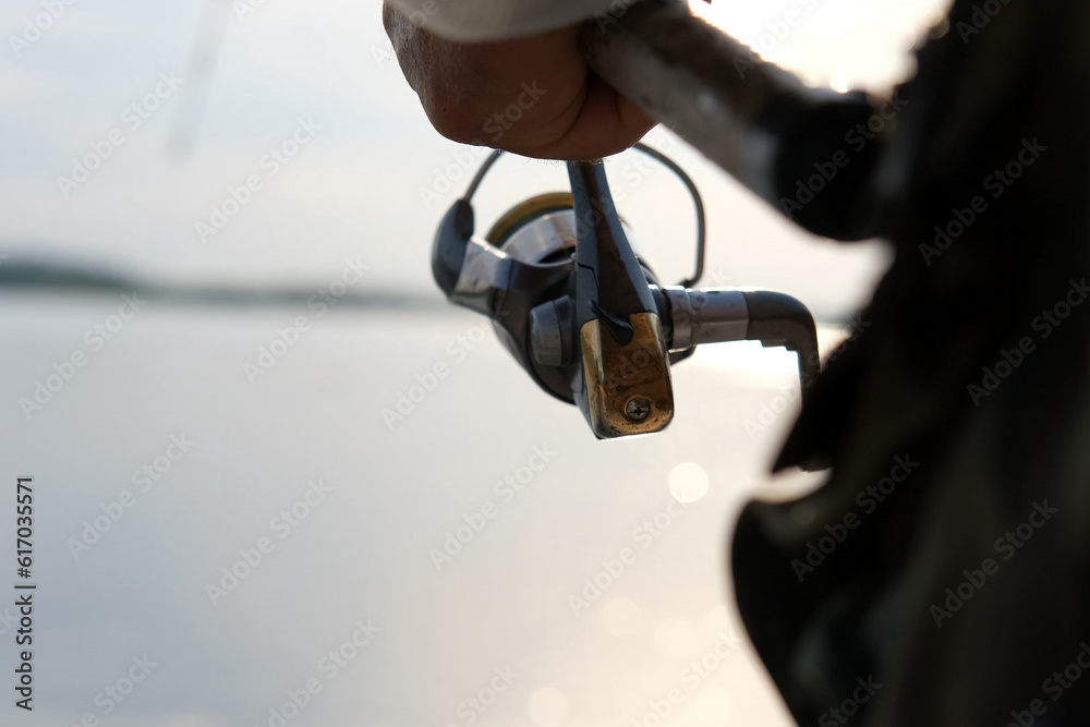 Old man fishing. Senior gray haired fisherman throws a spinning from ...