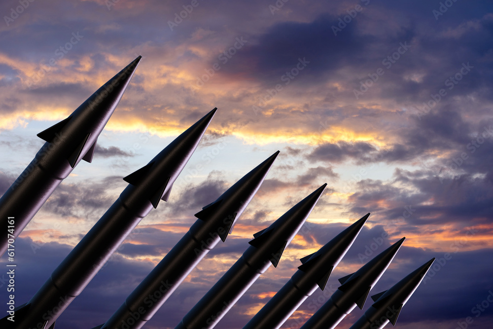 Row of nuclear ballistic missiles in silhouette ready to be launched at ...