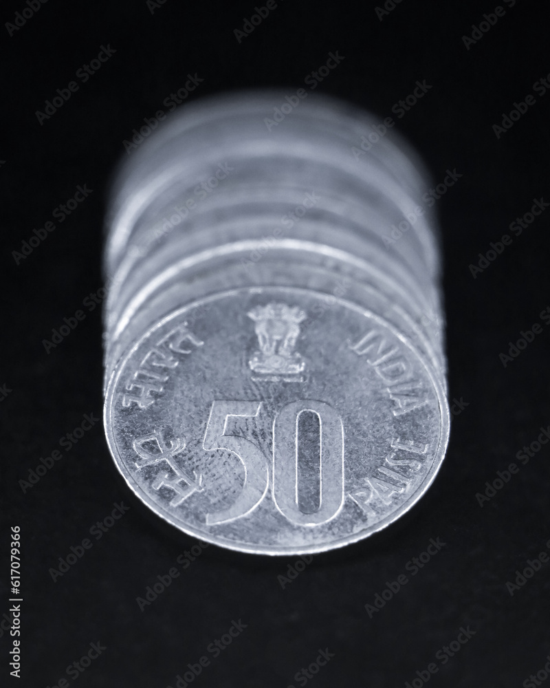 shiny vintage silver fifty or 50 paisa coins of india stacked together ...