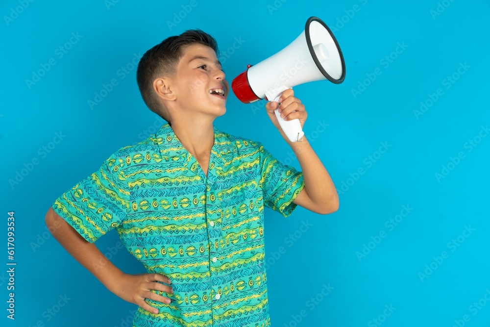Funny Little hispanic boy wearing green aztec shirt People sincere ...
