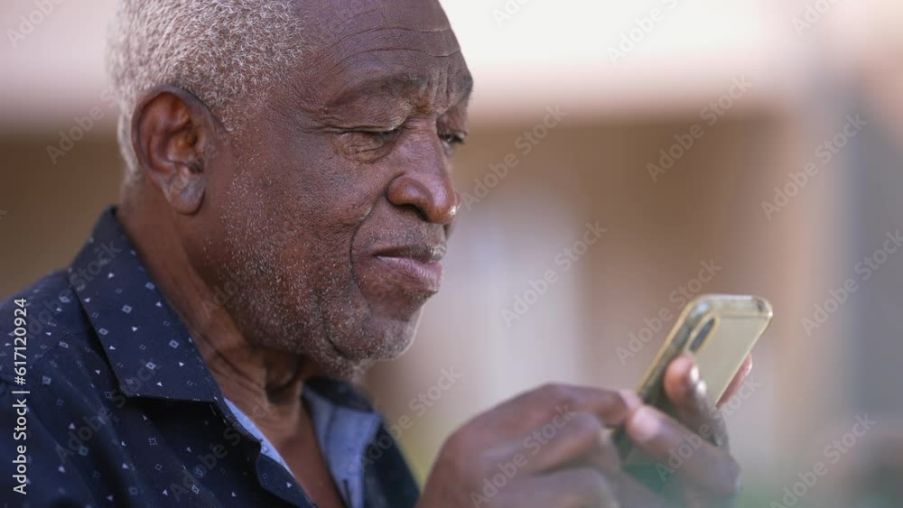 One senior black man scrolling through internet media with smartphone ...
