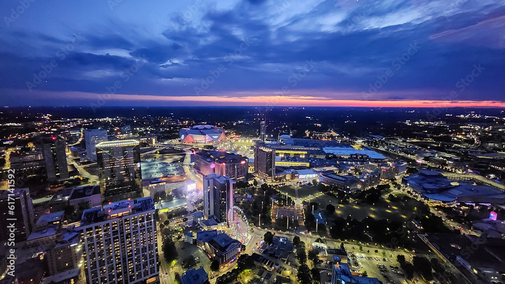 the city skyline at sunset with Mercedes-Benz Stadium, the SkyView ...