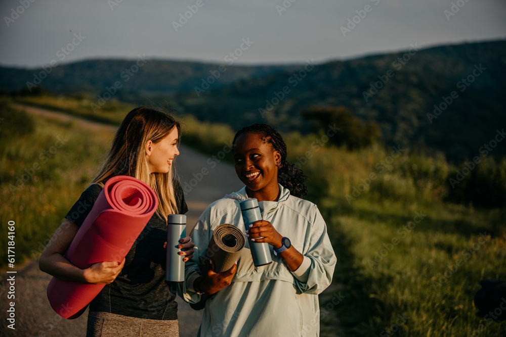 Unity in Nature: Against a backdrop of vibrant foliage, two women of ...
