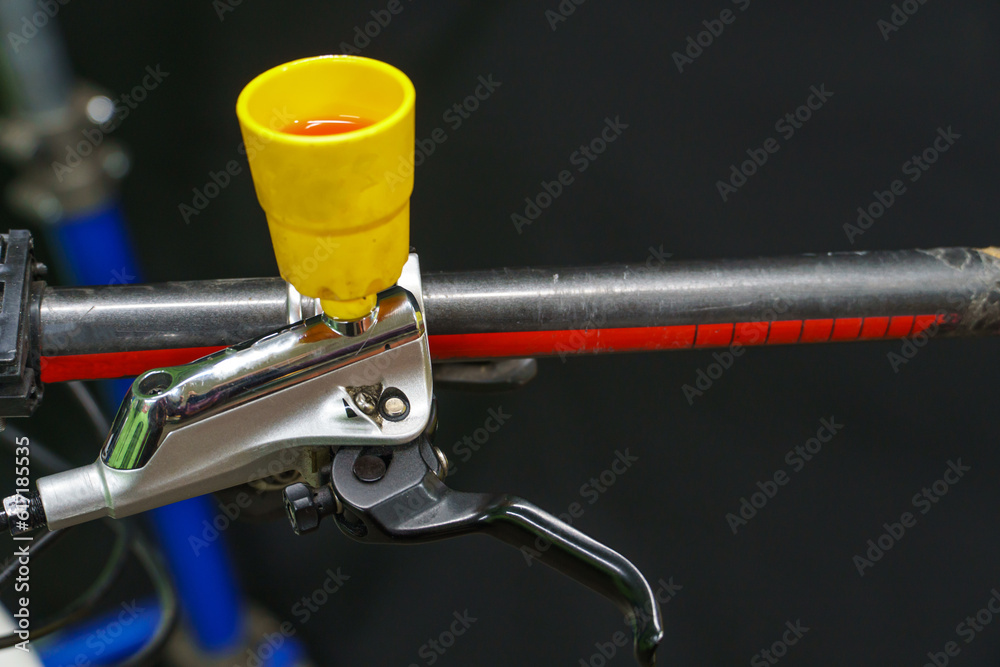 Bleeding the brake system of a mountain bike with a funnel. Bicycle ...