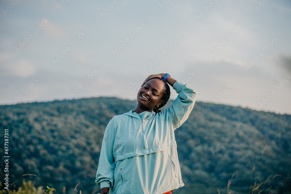 In a tranquil meadow, a black woman integrates her technology-infused ...
