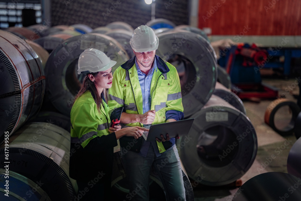 Professional engineering workers walk and check in warehouse factory ...
