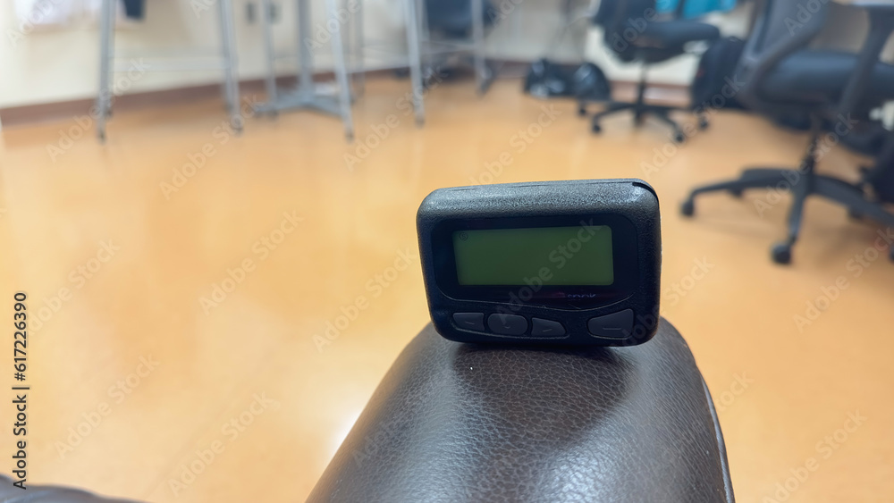 pager beeper device rests on a desk, representing the power of instant ...