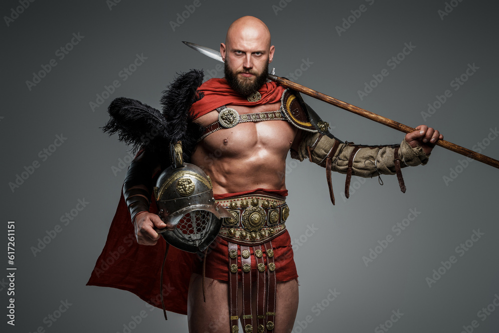 Confident bald gladiator with light armor and red cape, holding a spear ...