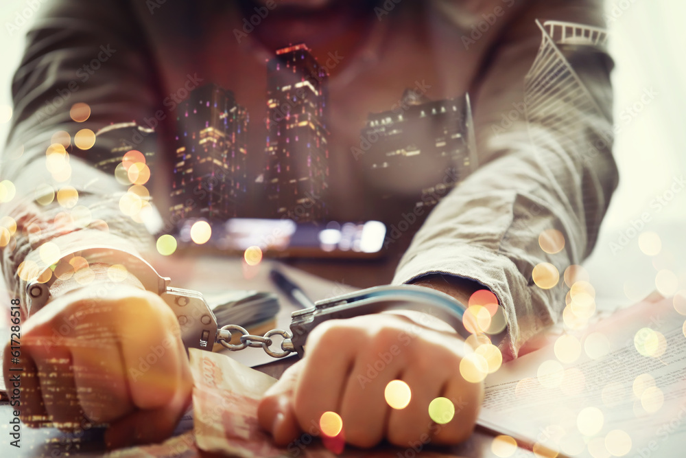 Double exposure of male hands locked in handcuffs city landscape ...