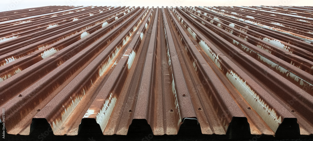 old rusty corrugated metal roof with white sky as background, barn ...