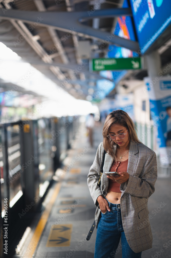 Asian woman stands in railcar waiting for an railcar in the subway ...