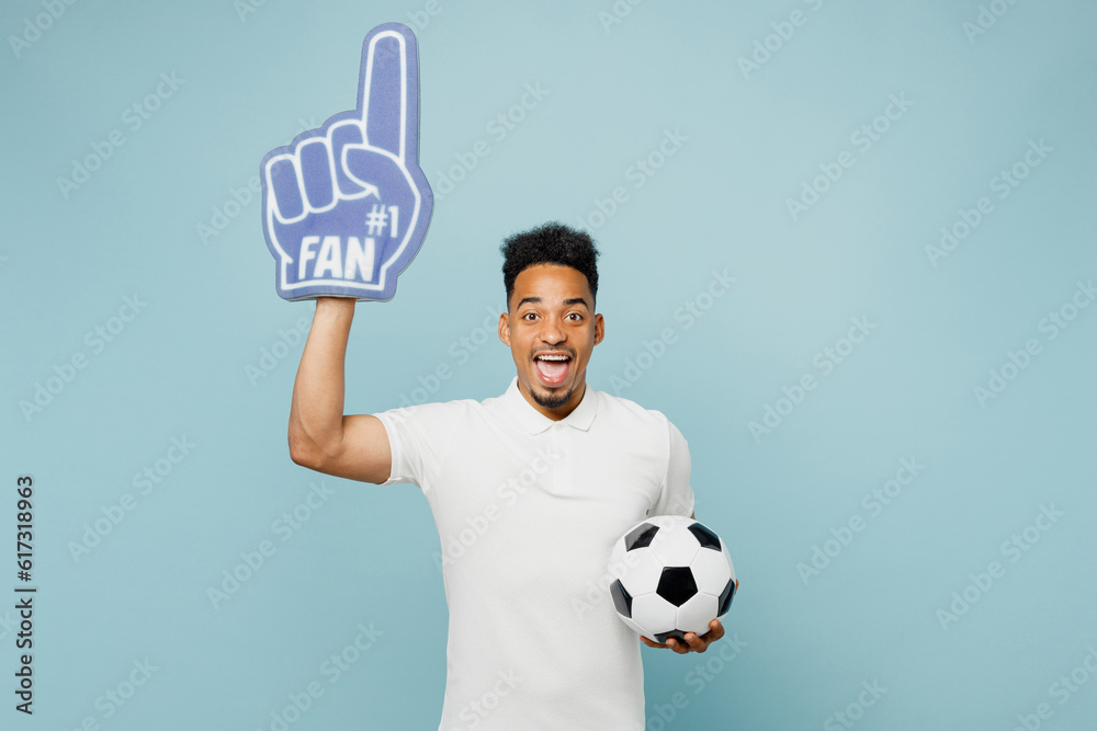 Young surpirsed man fan in t-shirt foam 1 fan glove finger up point ...