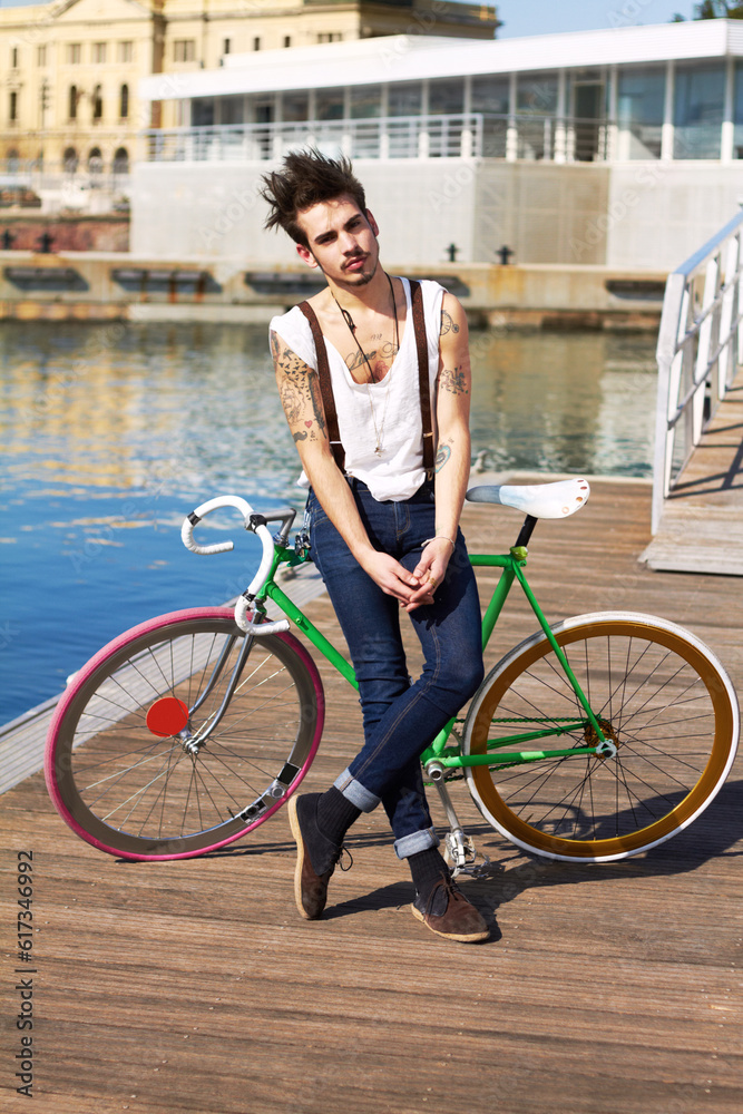 Bicycle, fashion and young man by the sea in a punk or rock outfit on ...