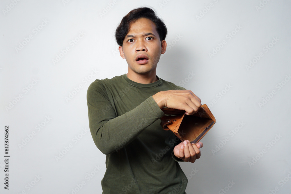 Adult Asian man showing his empty wallet with worried expression Stock ...