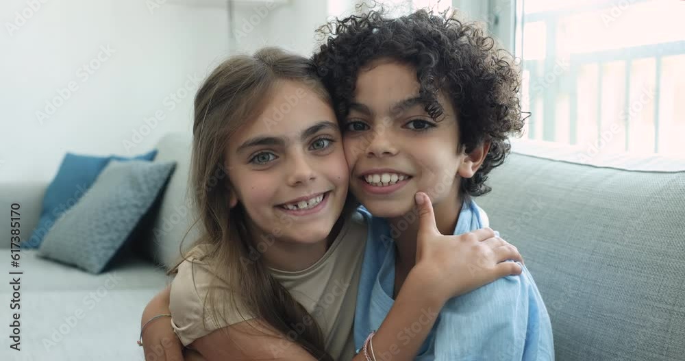 Loving Italian brother cuddling tightly little sister smile looking at ...